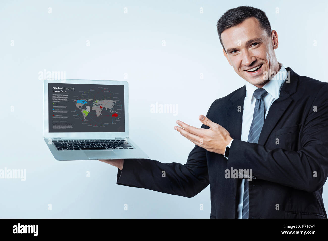 Joyful businessman pointing toward screen of laptop Stock Photo - Alamy