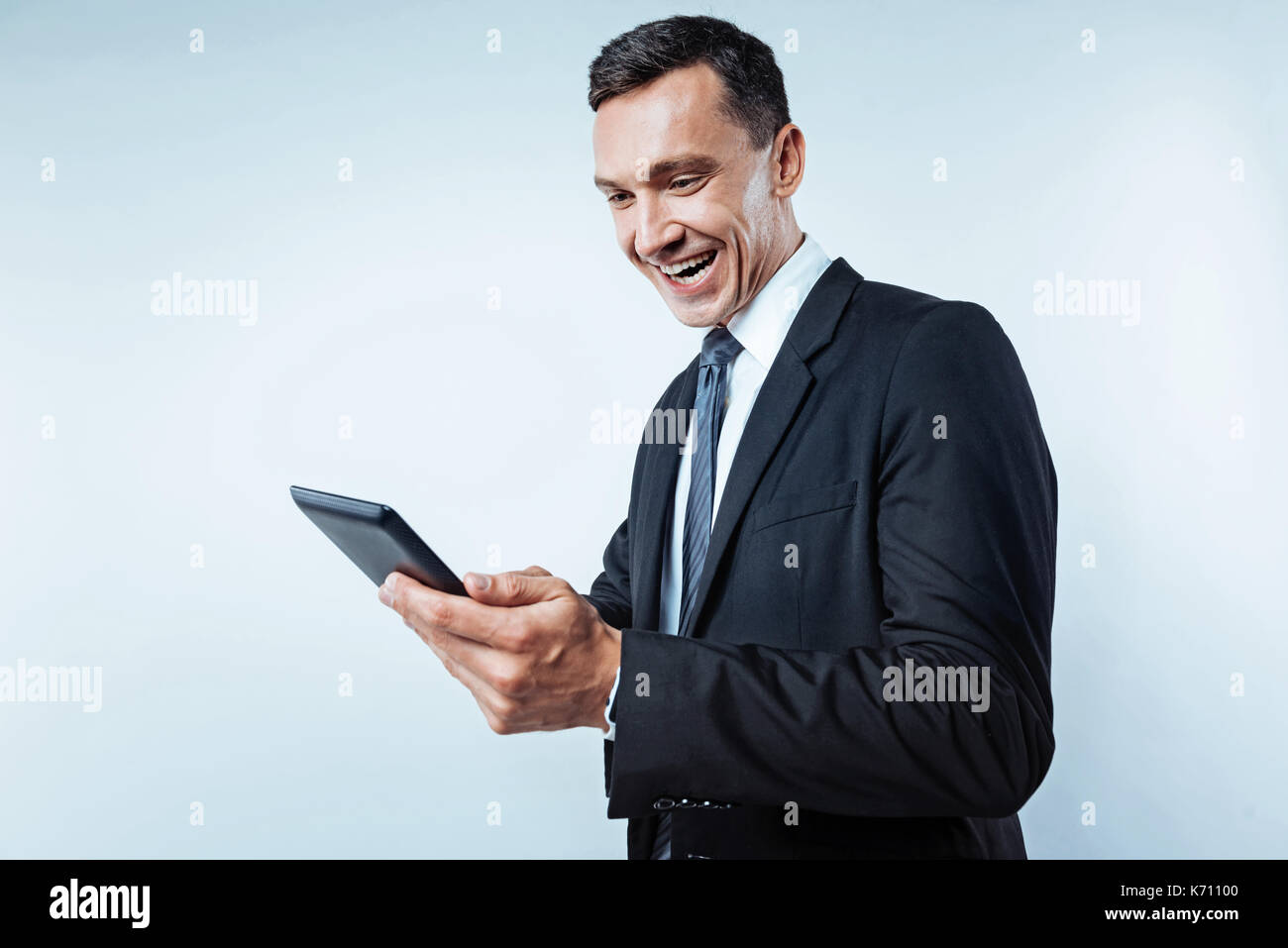 Radiant man of business using tablet computer Stock Photo - Alamy