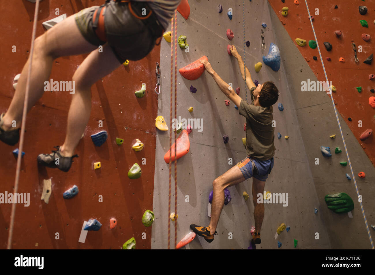 Male athletes climbing wall in fitness club Stock Photo - Alamy