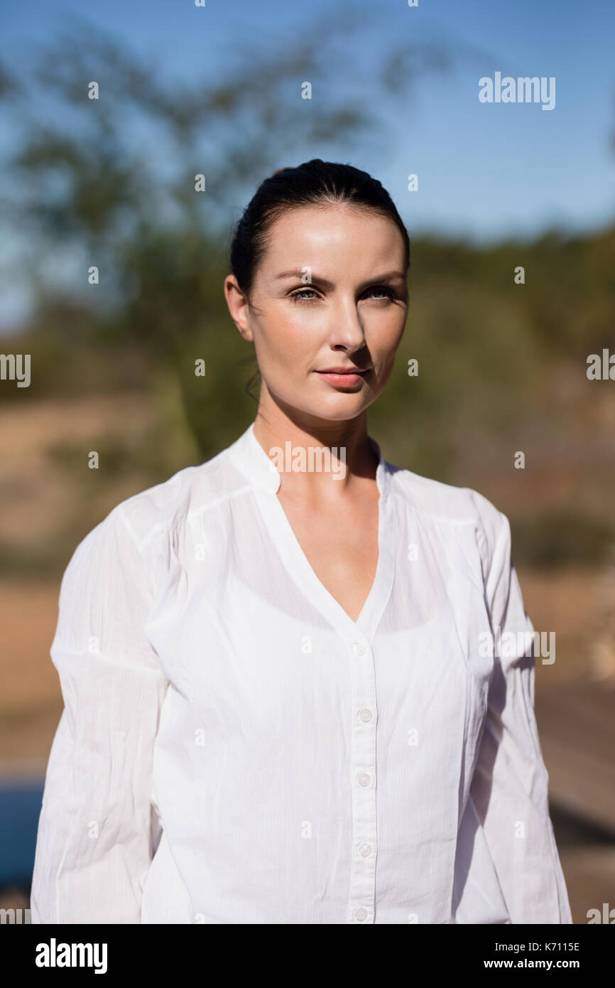 Portrait of woman standing in grassland Stock Photo - Alamy