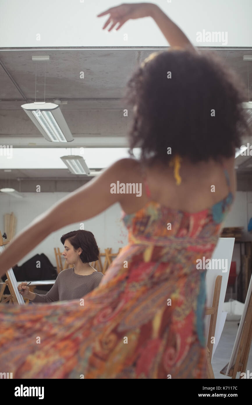 Female artist drawing a sketch of woman on canvas in art studio Stock ...