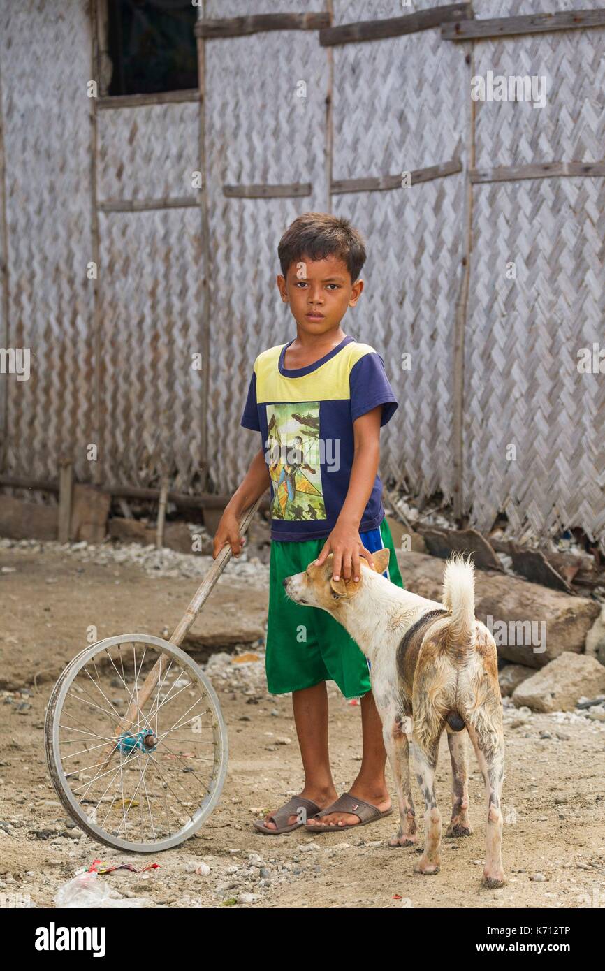 Philippines, Palawan, Calandagan Island, boy with a dog Stock Photo - Alamy