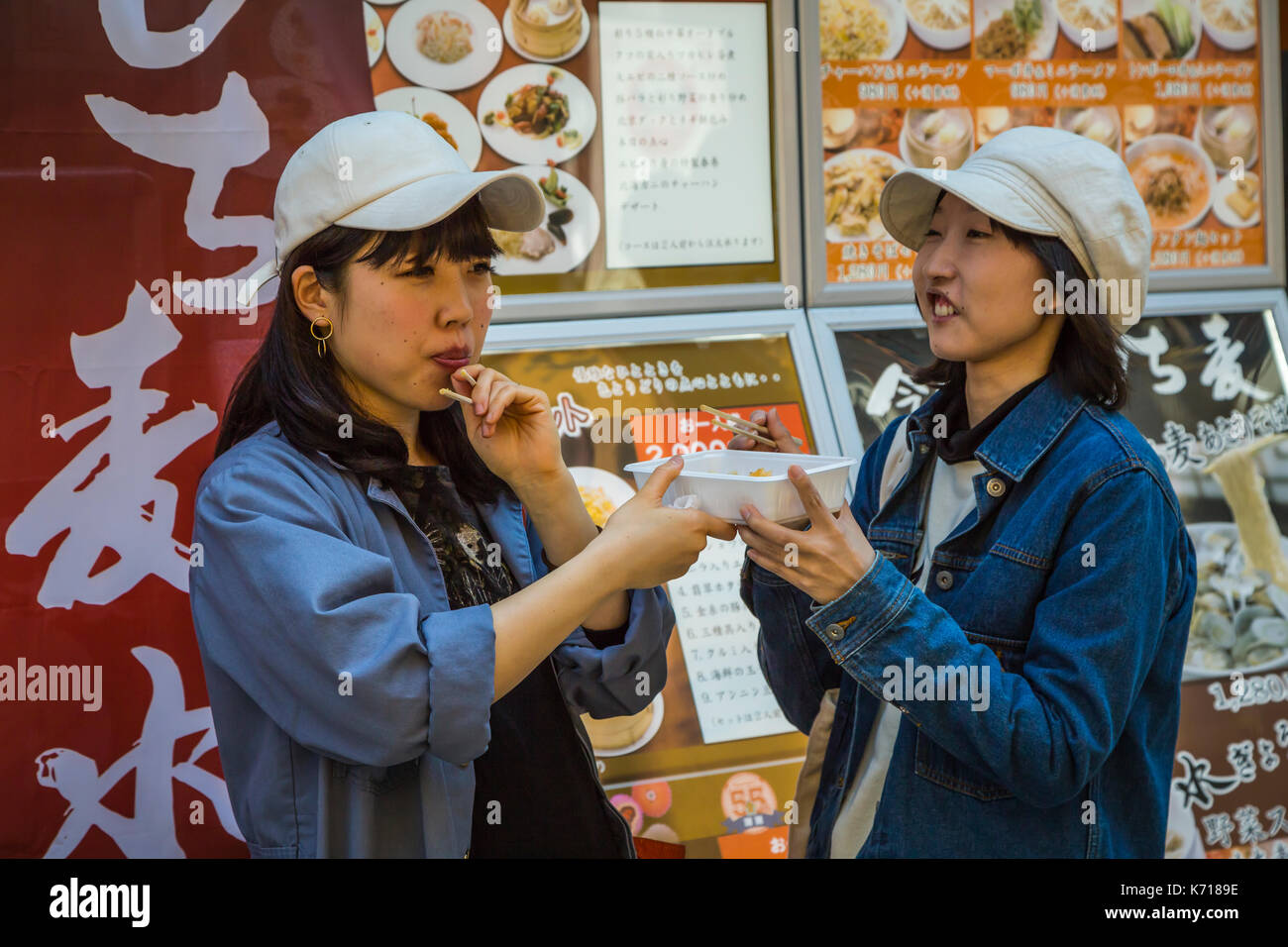 Japanese school girls sampling street food in Chinatown, Yokohama ...