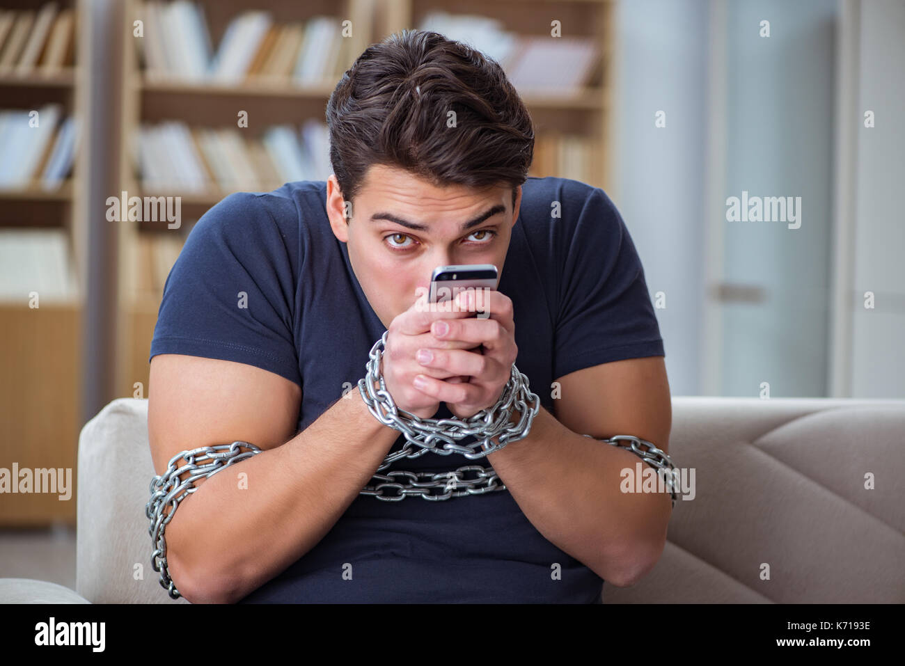Man suffering from phone dependence addiction Stock Photo - Alamy
