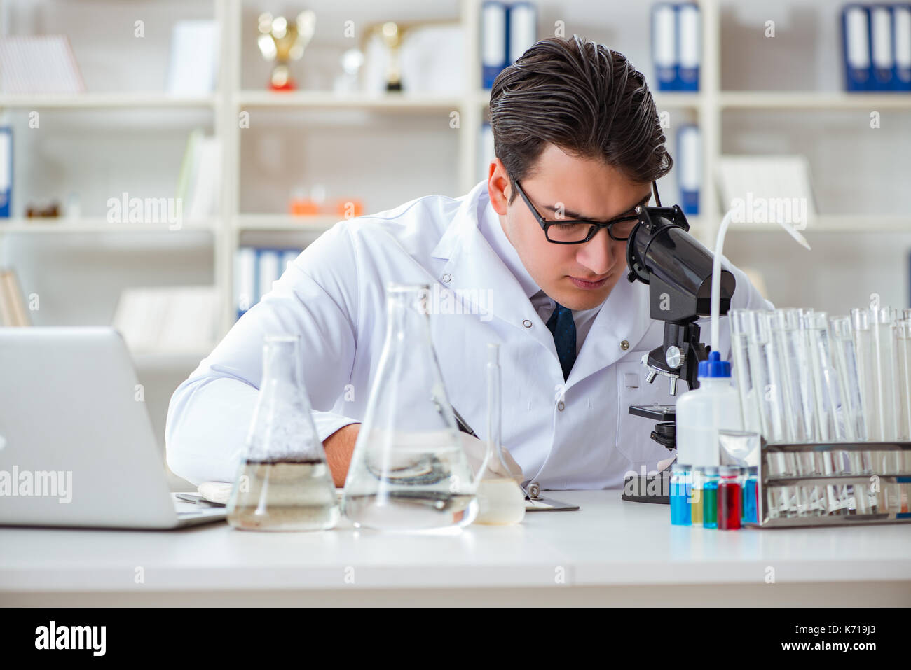 Young researcher scientist doing a water test contamination experiment ...