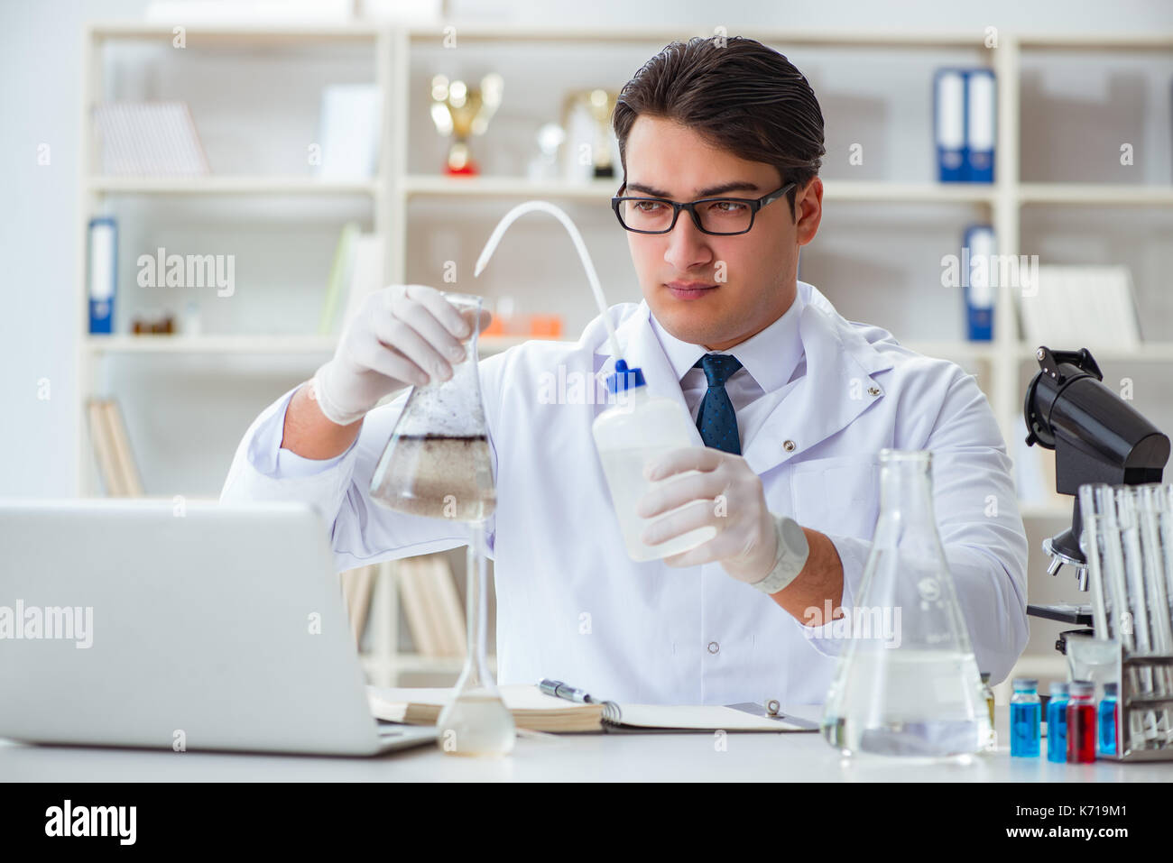 Young researcher scientist doing a water test contamination experiment ...