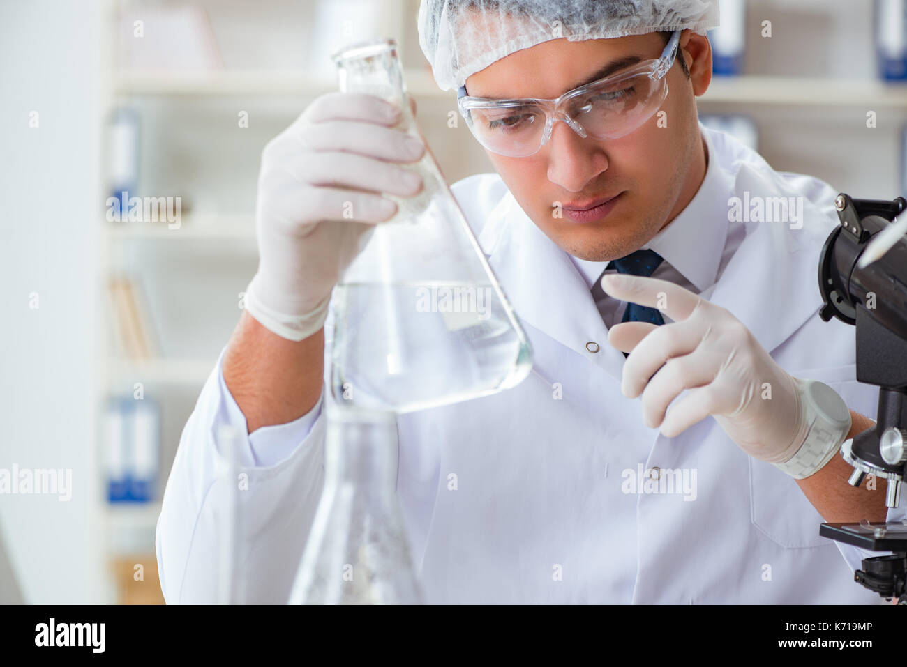 Young researcher scientist doing a water test contamination experiment ...