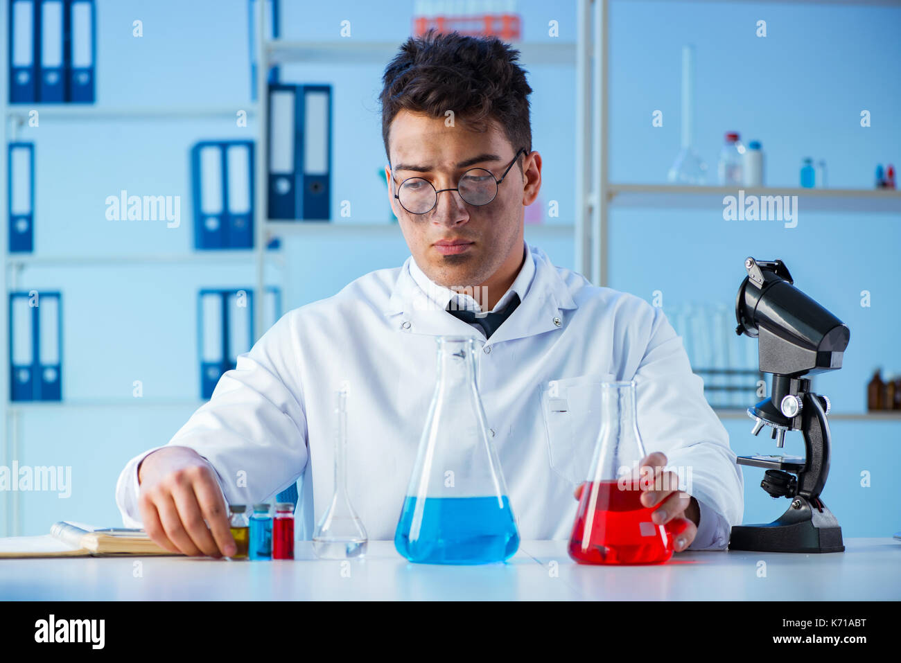 Funny mad chemist working in a laboratory Stock Photo - Alamy