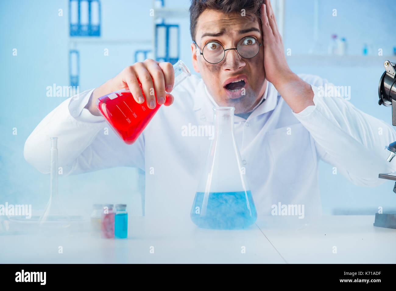 Funny mad chemist working in a laboratory Stock Photo - Alamy