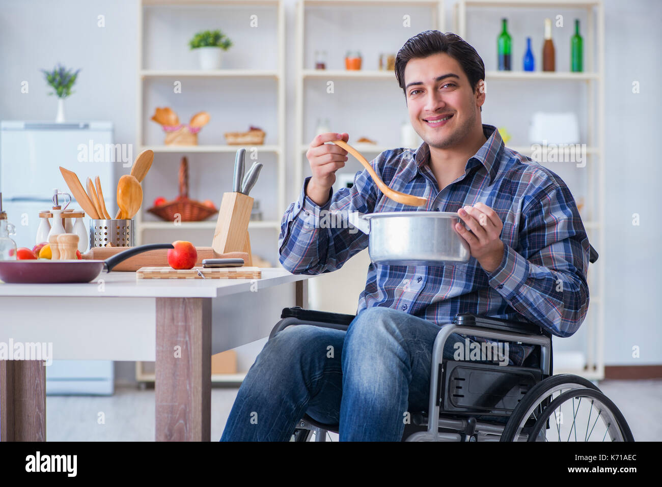 Disabled man preparing soup at kitchen Stock Photo - Alamy