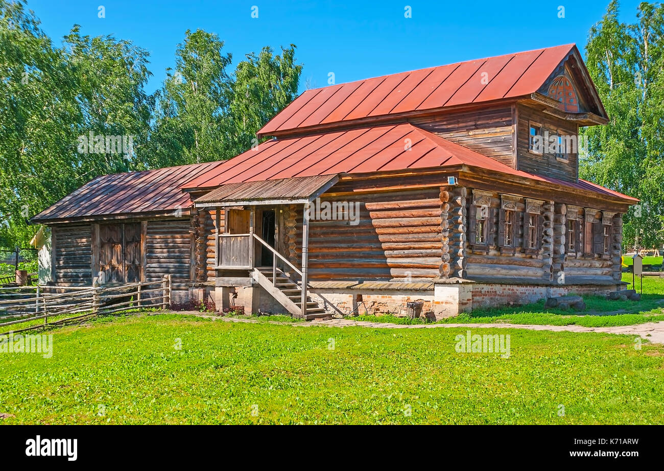 The traditional Russian log house among the greenery in open air ...