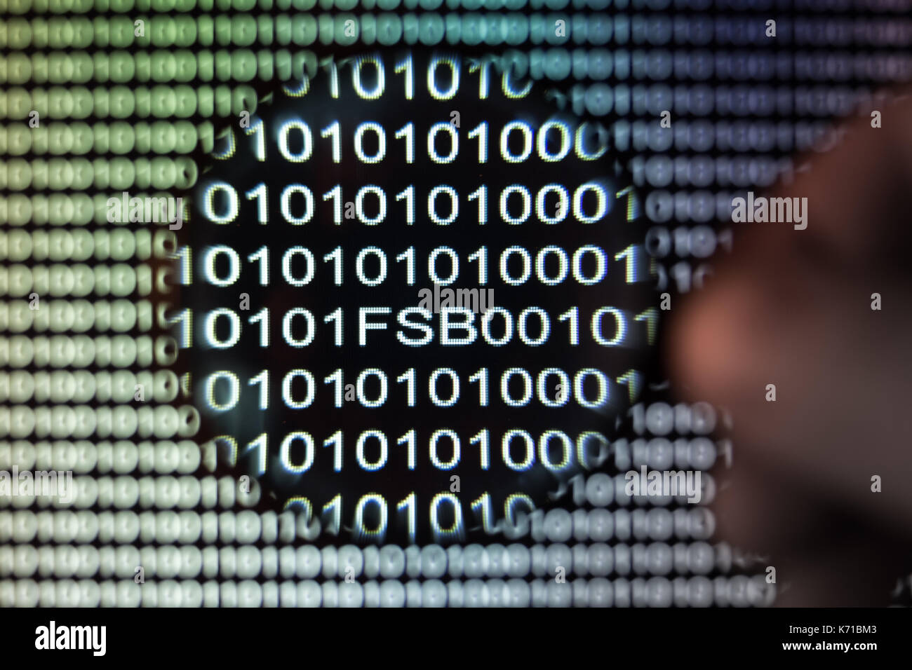 Binary code, Magnifying glass shows russian FSB, intelligence Stock ...