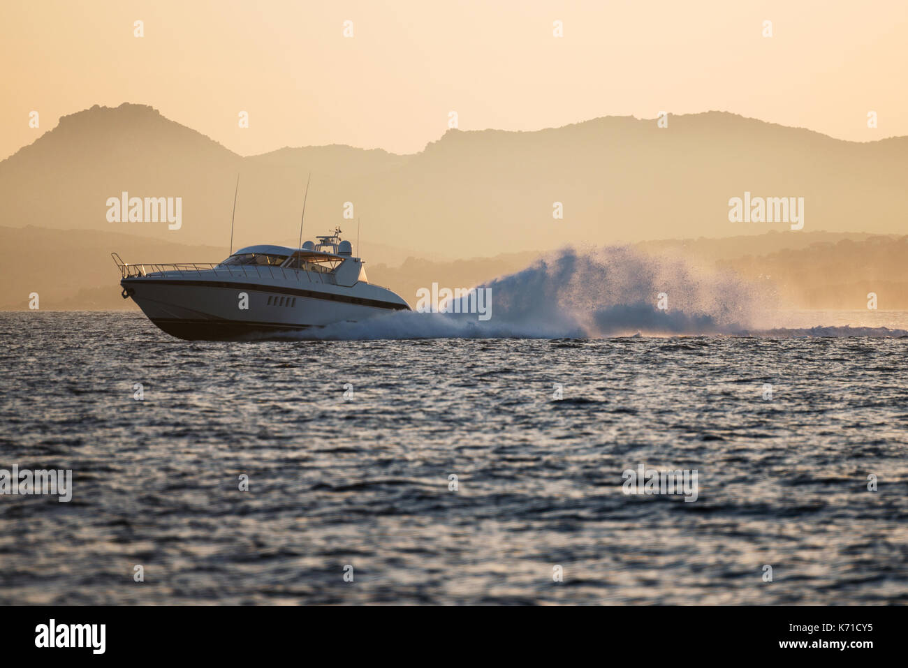 Fast motor speed boat at sunset Stock Photo - Alamy