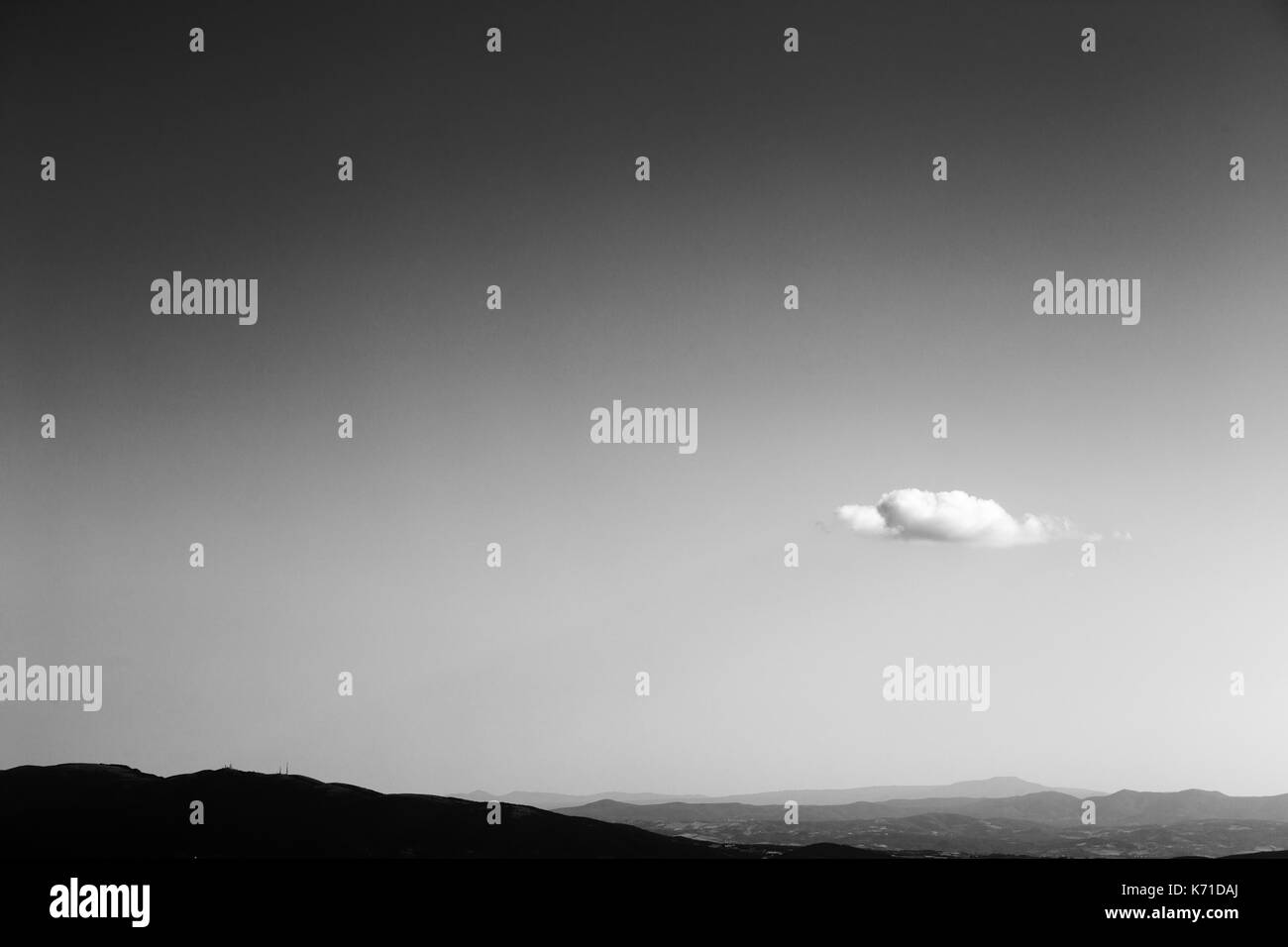 Minimalist view of an almost empty sky with a small white cloud, over ...