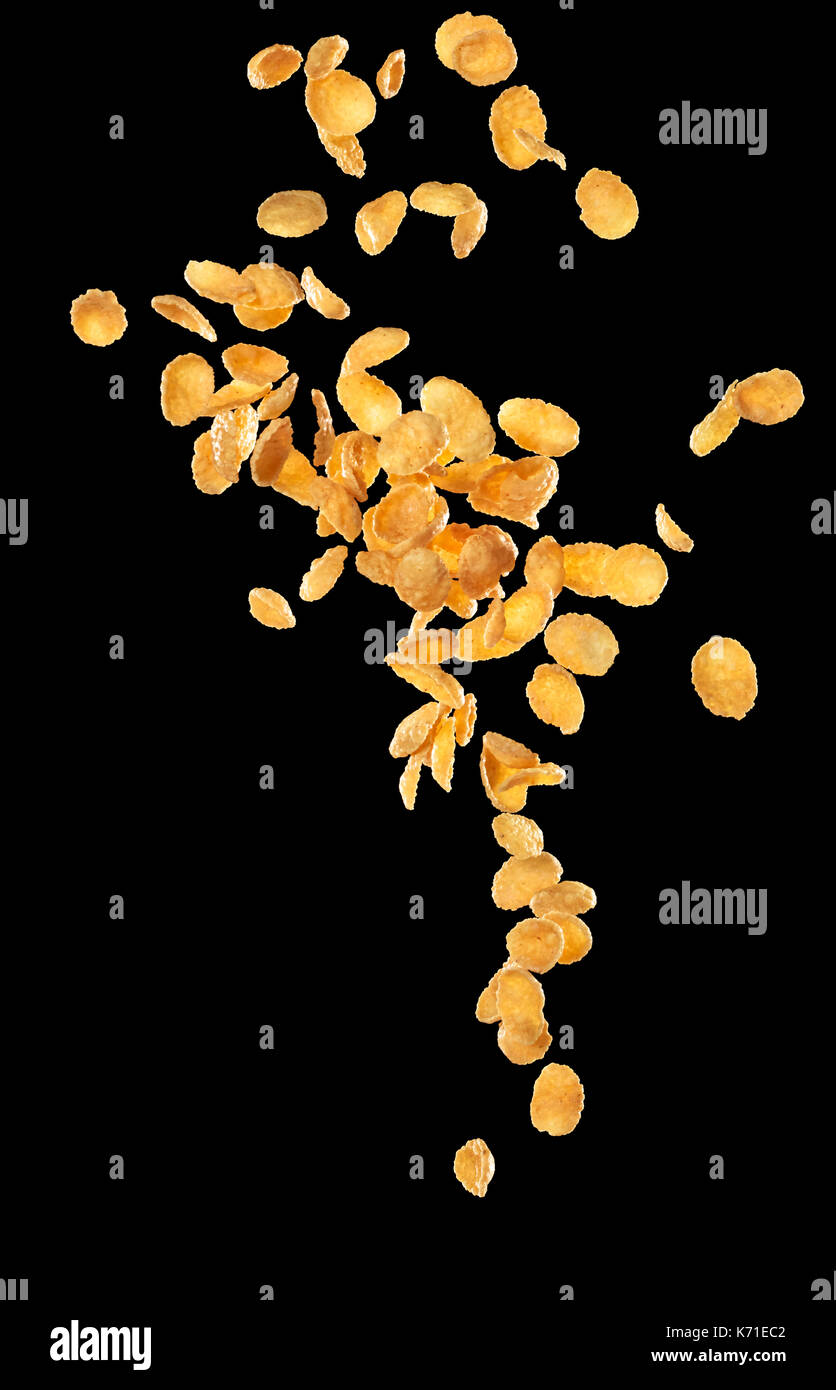 corn flakes flying isolated on black background Stock Photo - Alamy