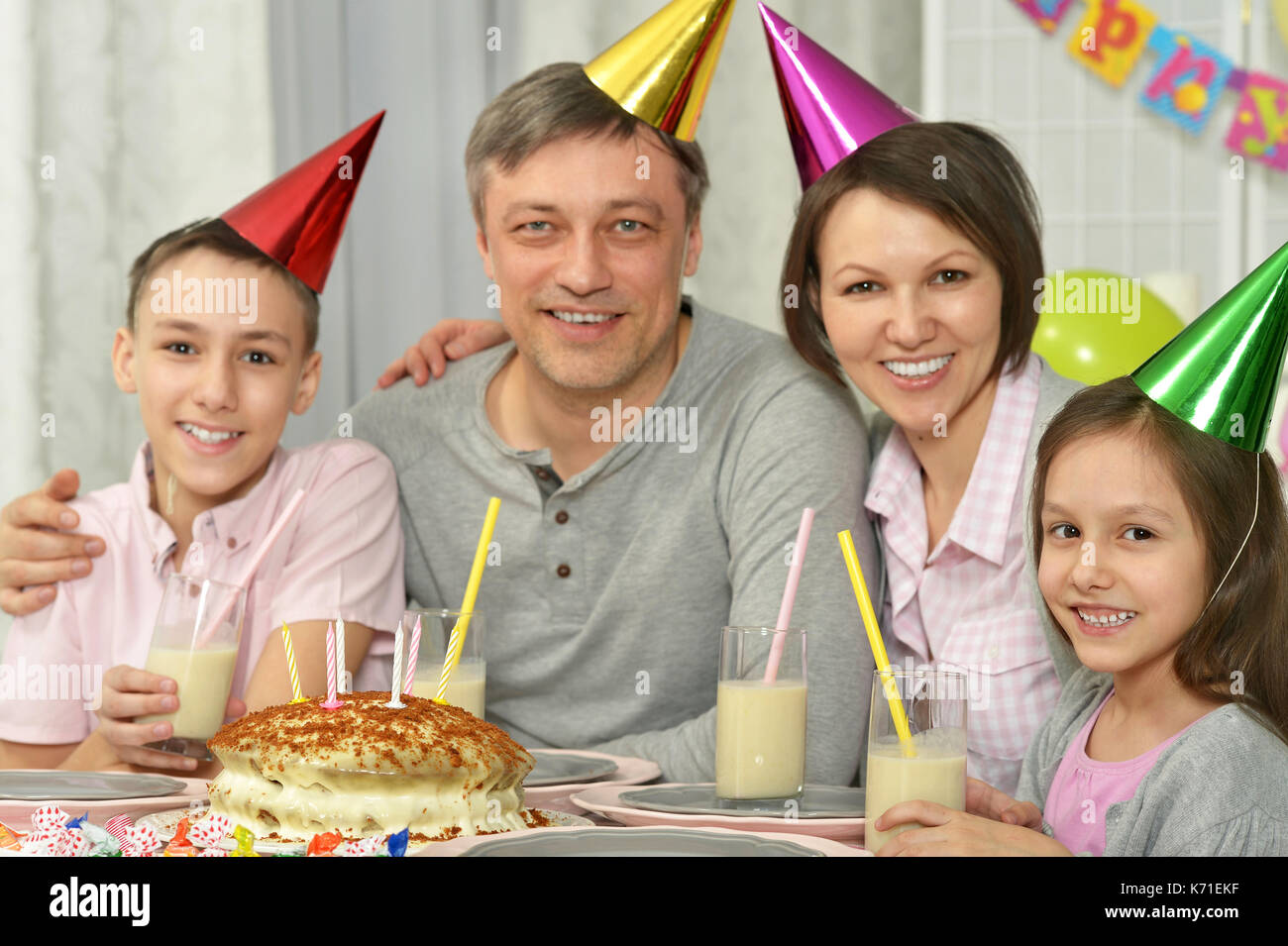 Parents and children celebrating birthday Stock Photo - Alamy