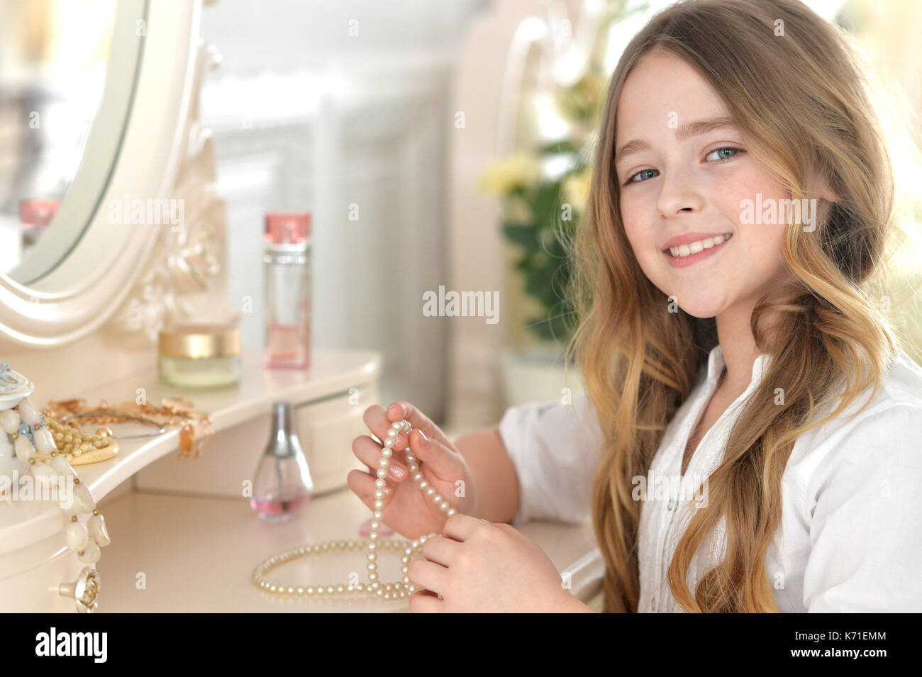 Cute girl at dressing table Stock Photo - Alamy