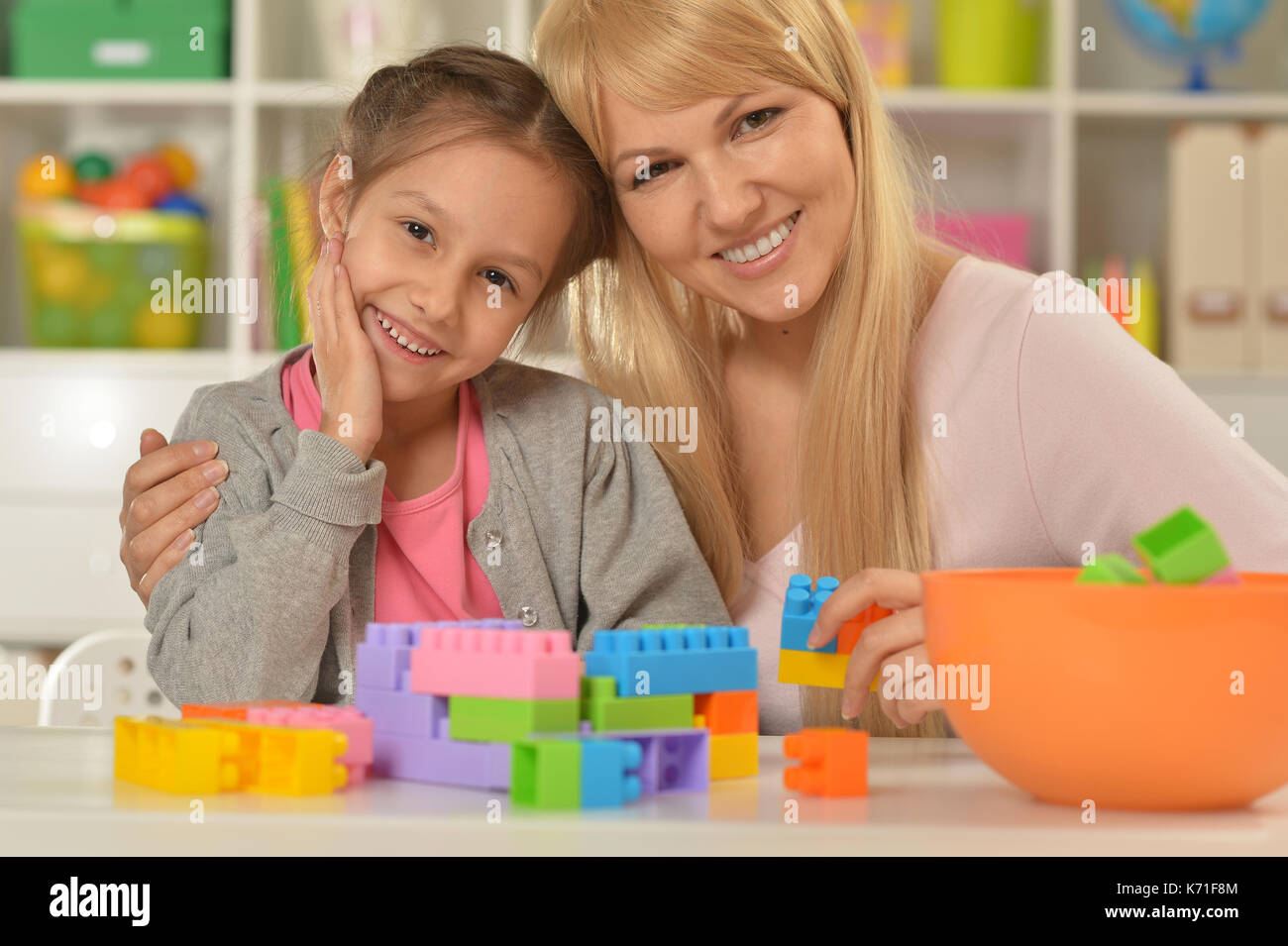 mother and daughter collecting blocks Stock Photo - Alamy