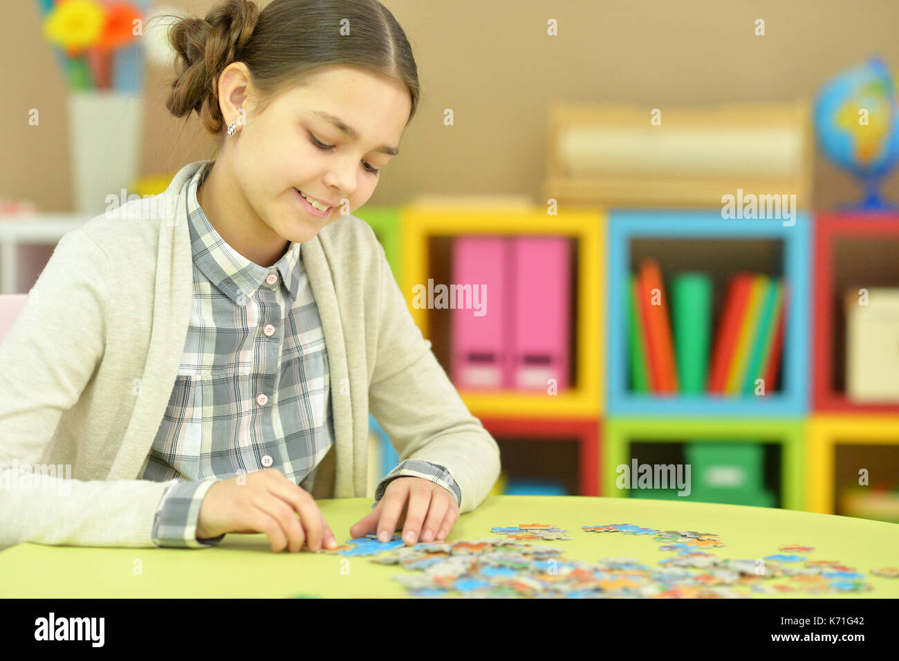 Teen girl collecting puzzle pieces Stock Photo - Alamy