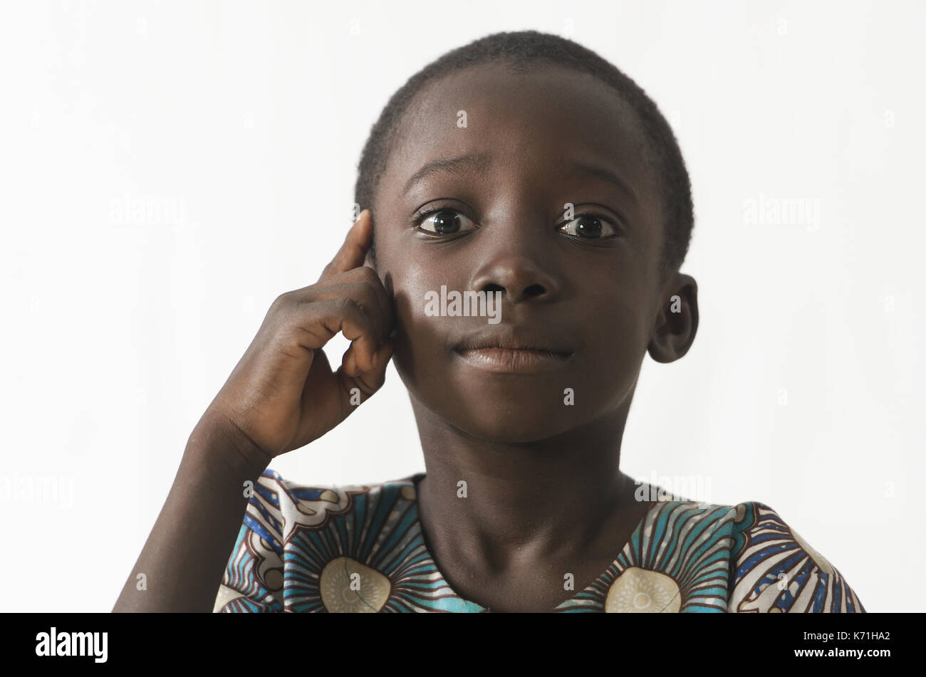 Little African child thinking has an idea, isolated on white Stock ...