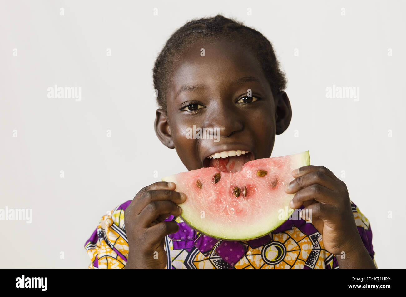 Hunger symbol - African child enjoying some watermelon - isolated on ...