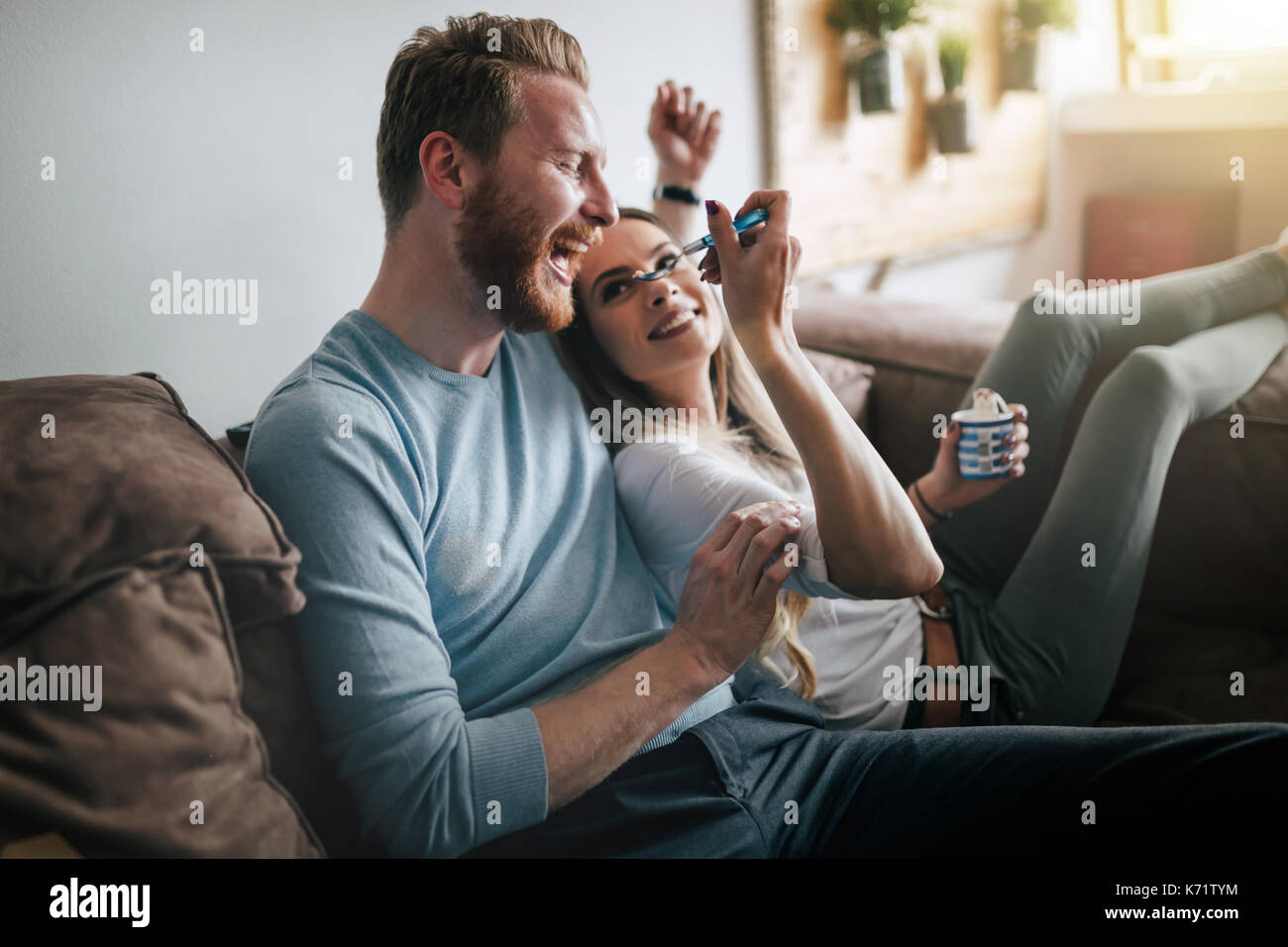 Romantic couple eating ice cream together and watching tv Stock Photo ...