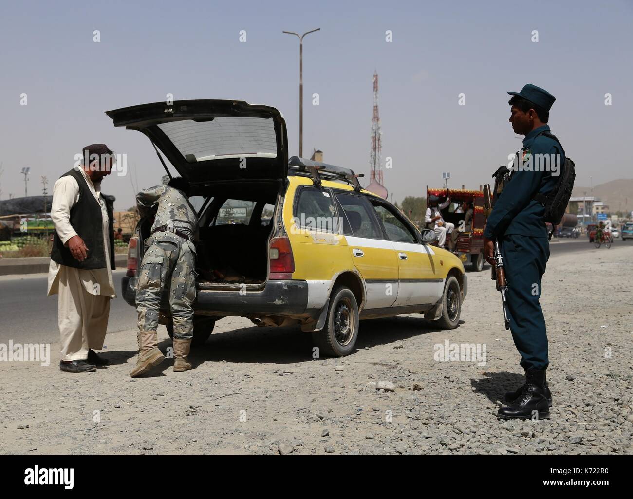 Ghazni. 14th Sep, 2017. An Afghan security officer checks a man at a ...