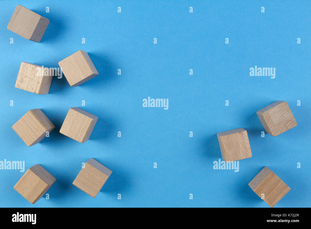 Wooden cubes on light blue background. Top view Stock Photo - Alamy