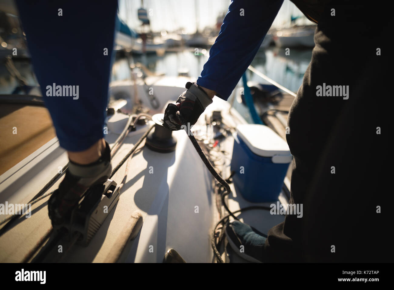 Mid-section of yachtsman adjusting ropes on the boat Stock Photo - Alamy