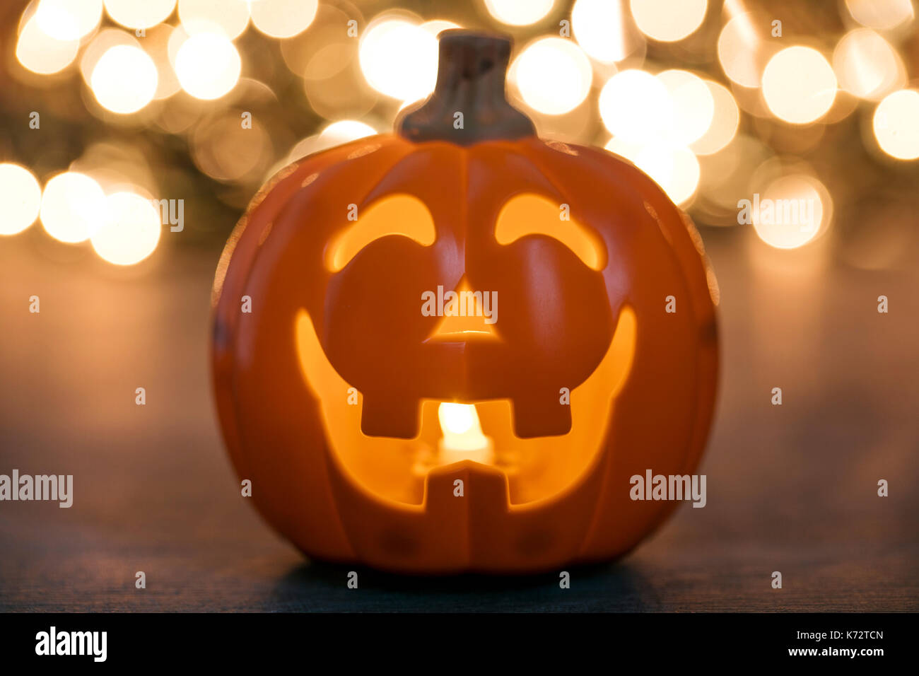 Glowing halloween pumpkin against bright lights Stock Photo - Alamy