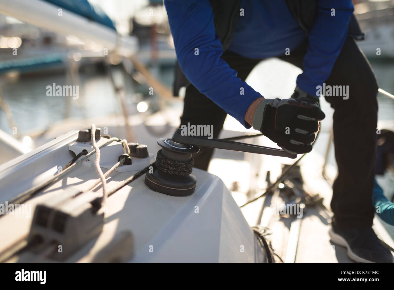 Mid-section of man pulling winch rope on boat Stock Photo - Alamy