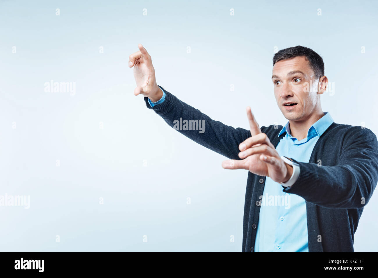 Surprised man touching transparent screen Stock Photo - Alamy