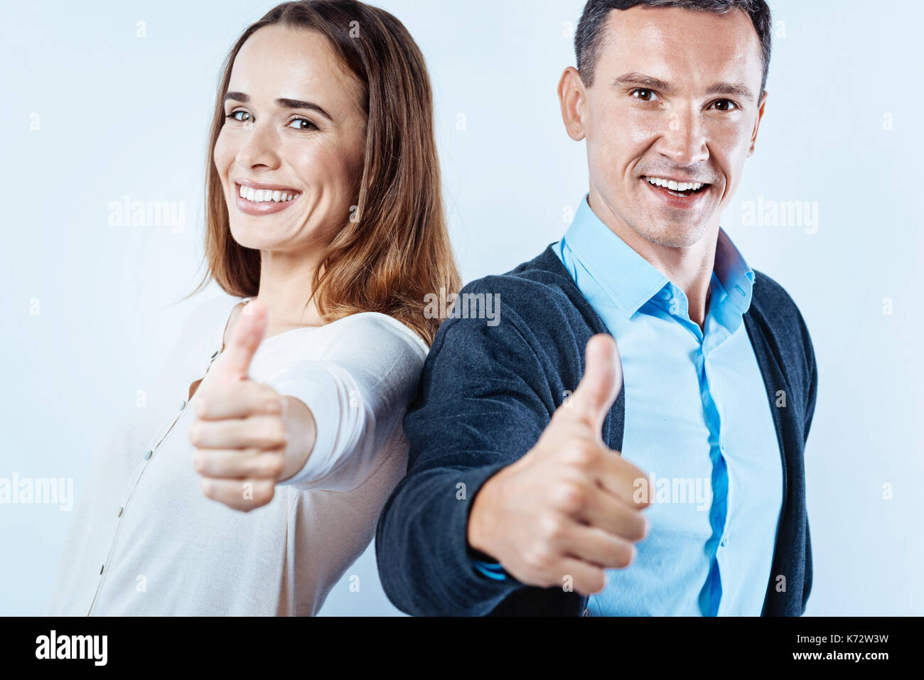 Satisfied woman and man showing super sign Stock Photo - Alamy