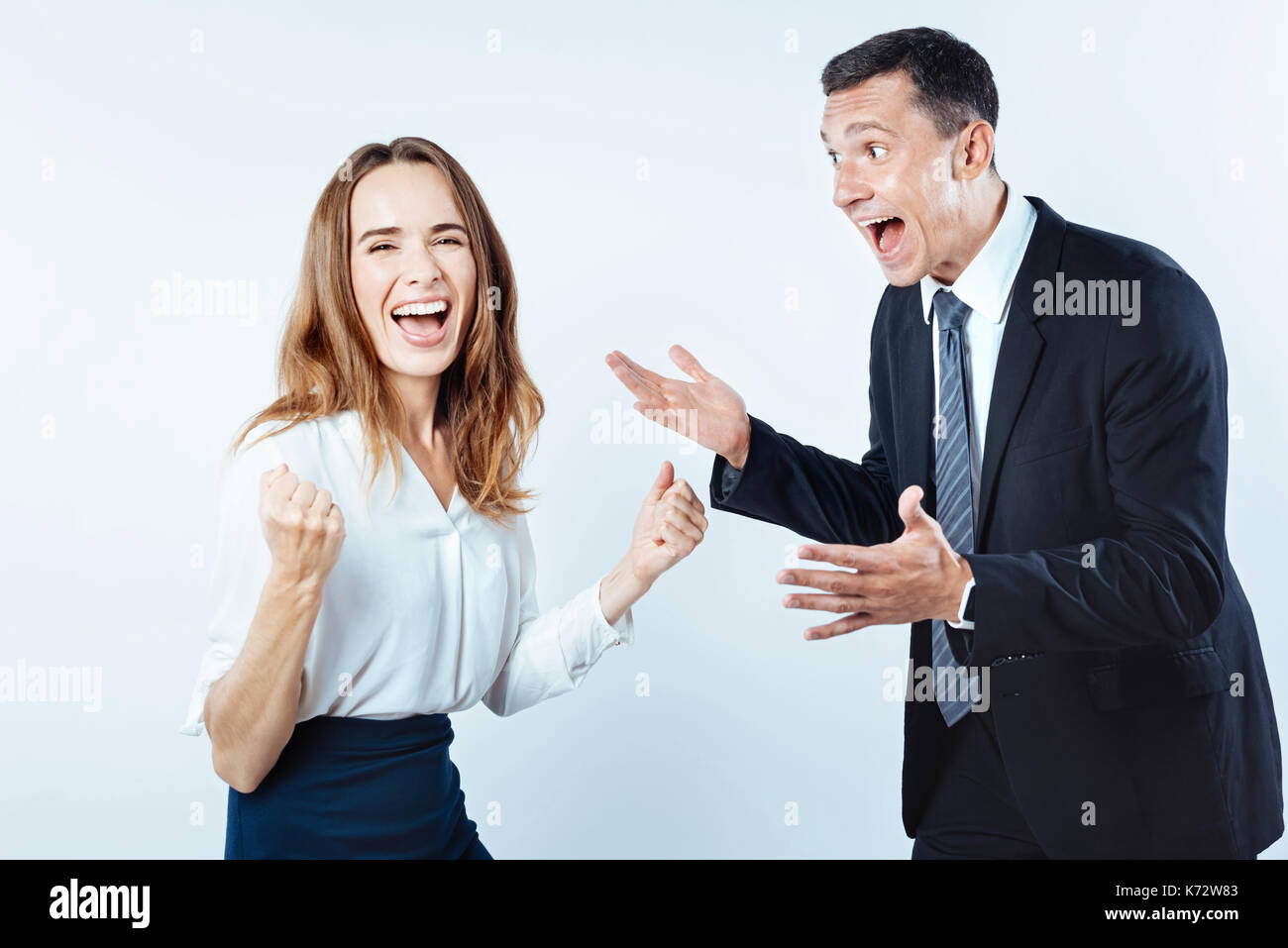Very emotional coworkers getting excited together Stock Photo - Alamy