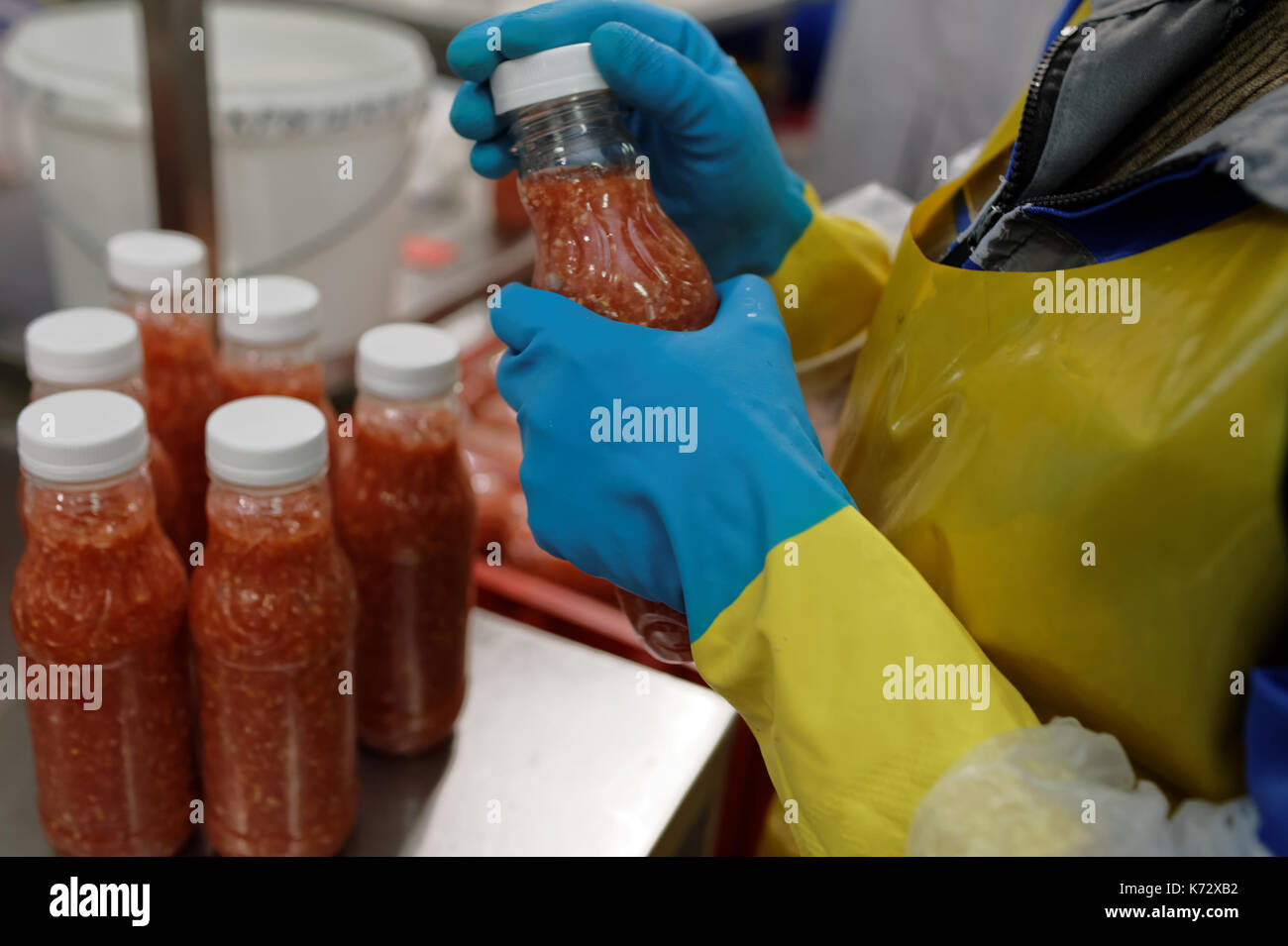 St. Petersburg, Russia - February 28, 2017: Worker packaging ajika ...
