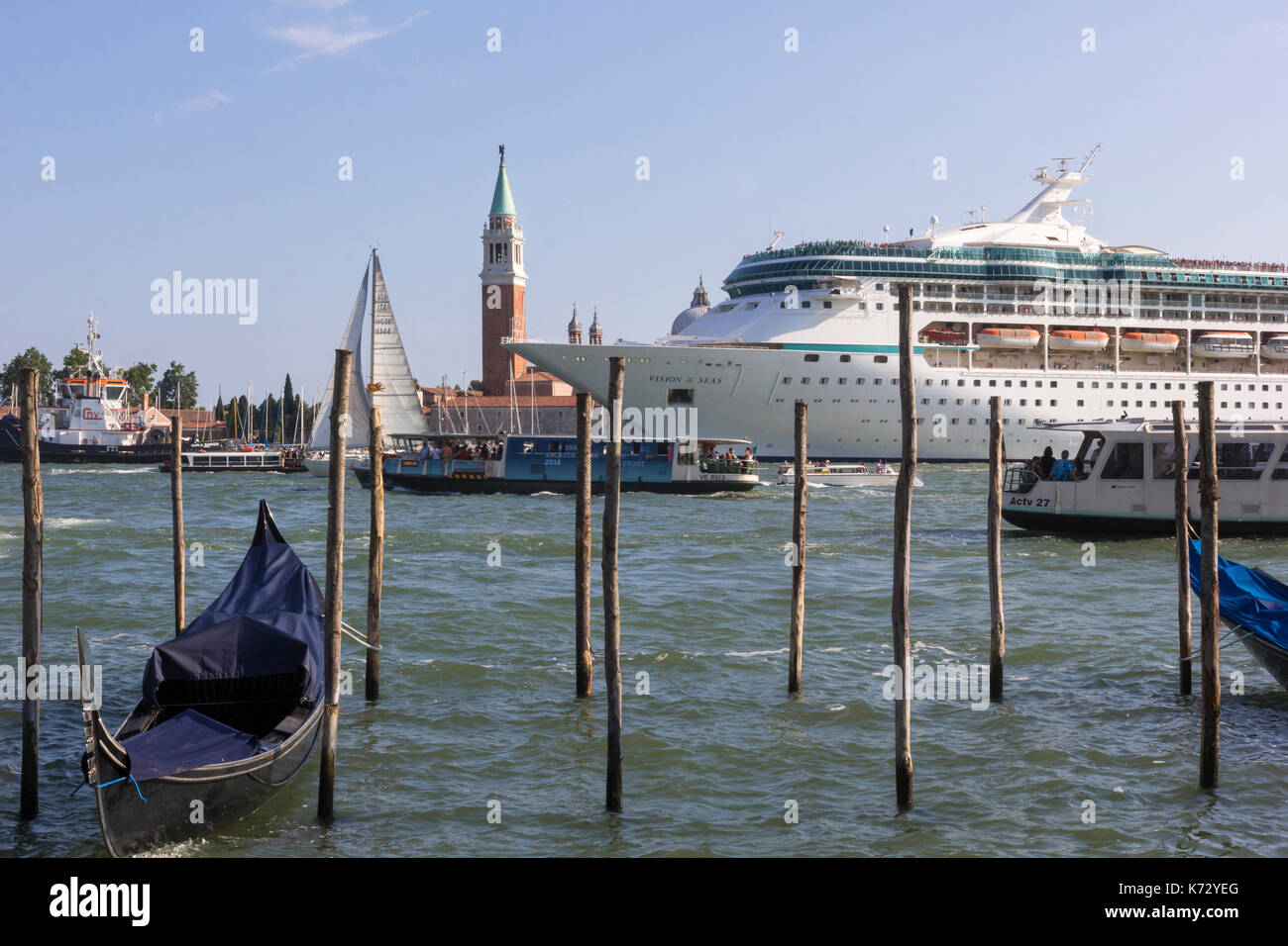 A cruise ship on its way in Venice, Italy, with a gondola on the ...