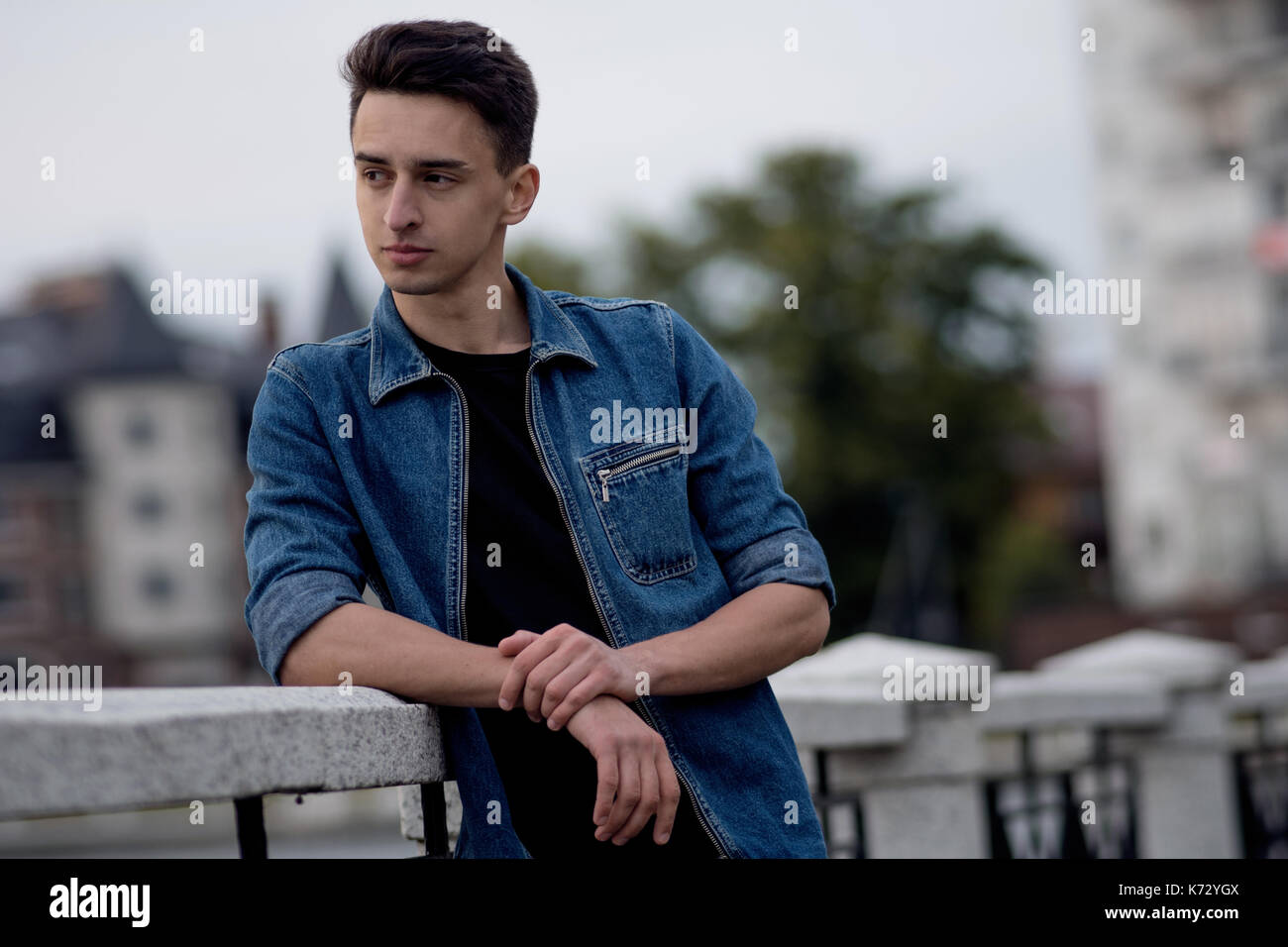 Brooding young guy in denim, walks on the street Stock Photo - Alamy