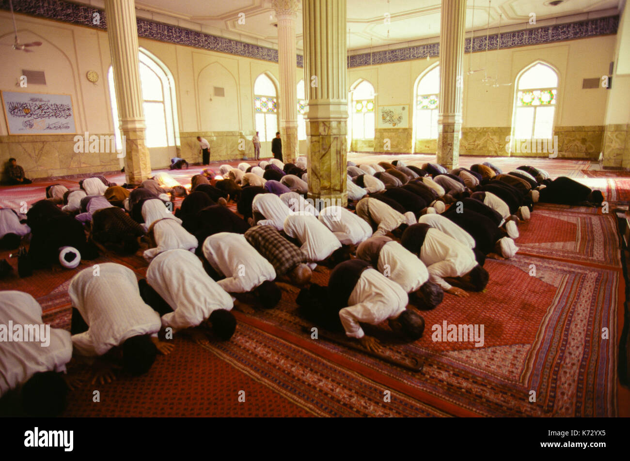 Iranian men praying at a seminary school mosque in Qom Stock Photo - Alamy