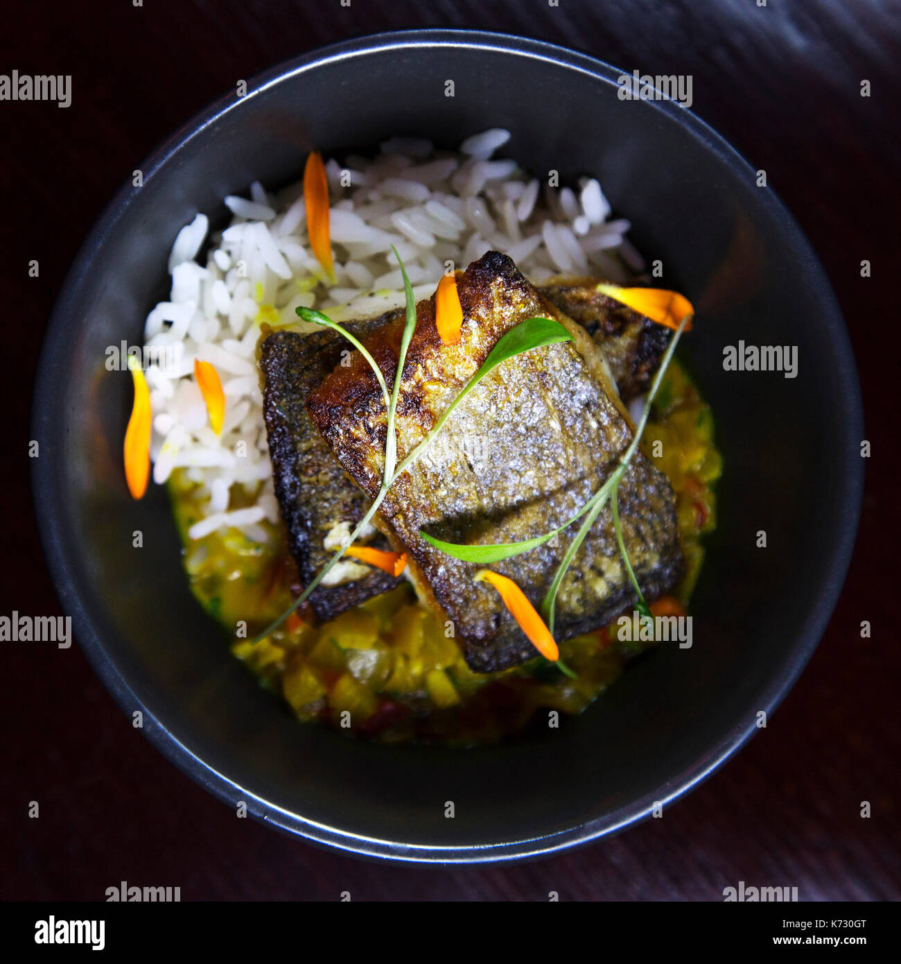 Sea bream, with crispy skin, served with rice as a tapas-style dish ...