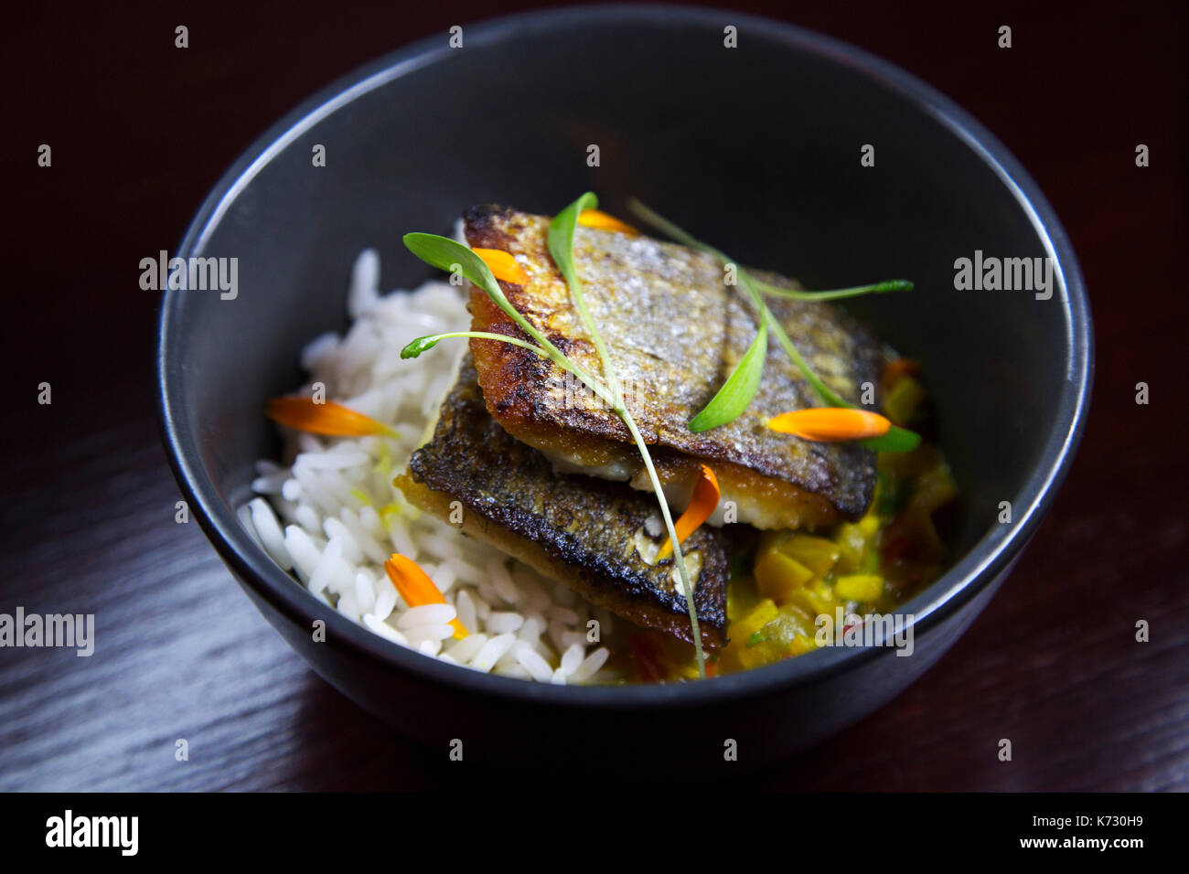 Sea bream, with crispy skin, served with rice as a tapas-style dish ...
