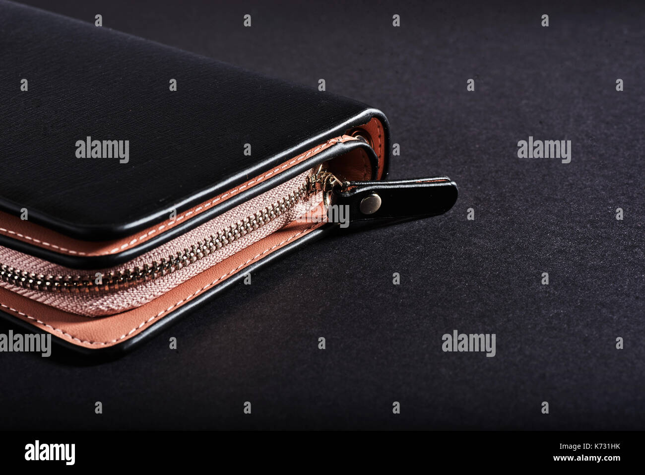 black wallet, isolated on a black background Stock Photo - Alamy
