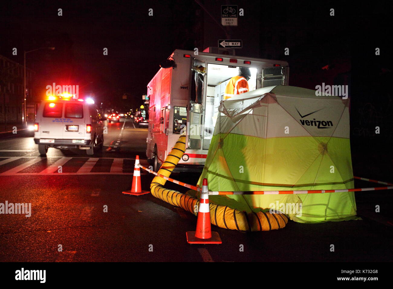 Public utility crews work during the night to restore power and other ...