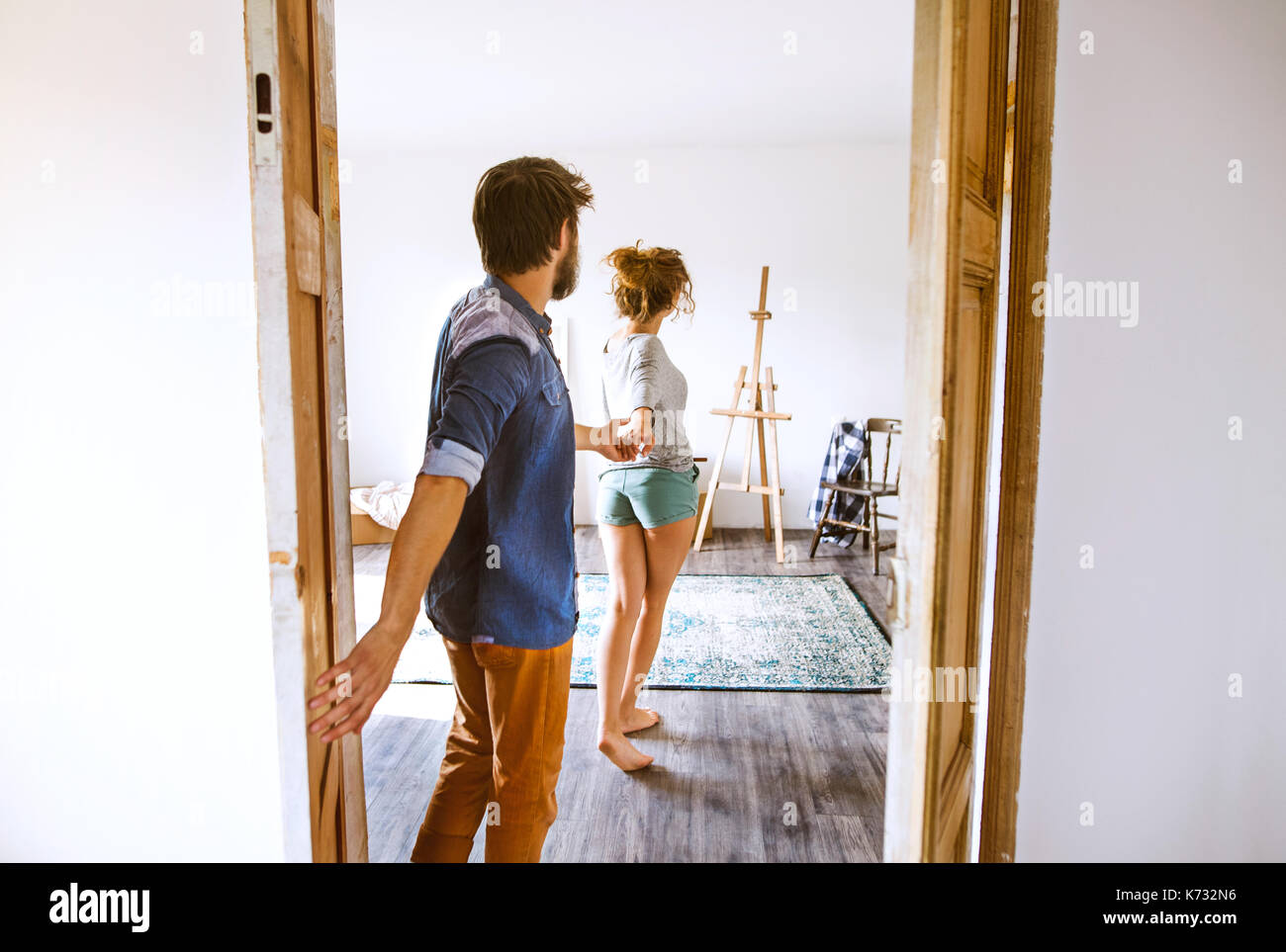 Couple moving in new house, entering through the door Stock Photo - Alamy