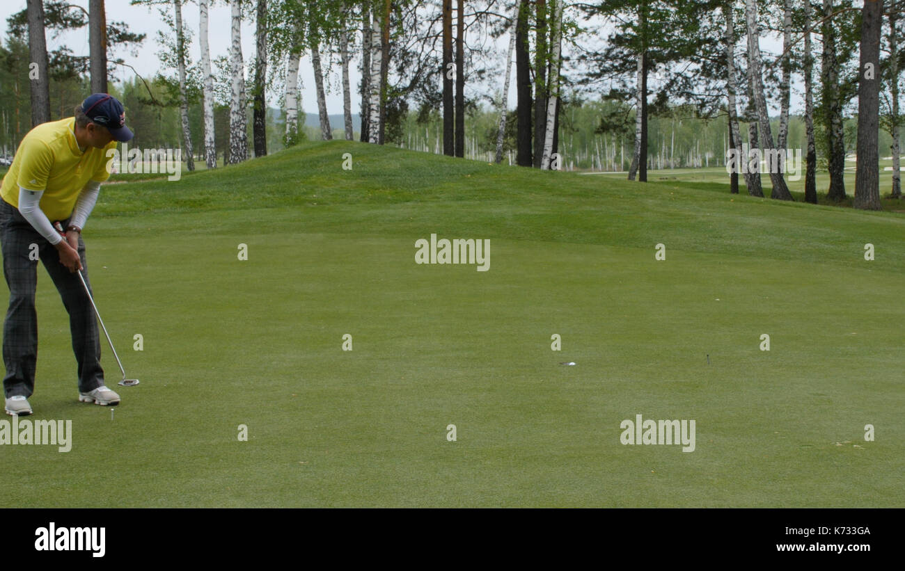 Golfers hit sweeping golf course in the summer. The game of Golf Stock ...