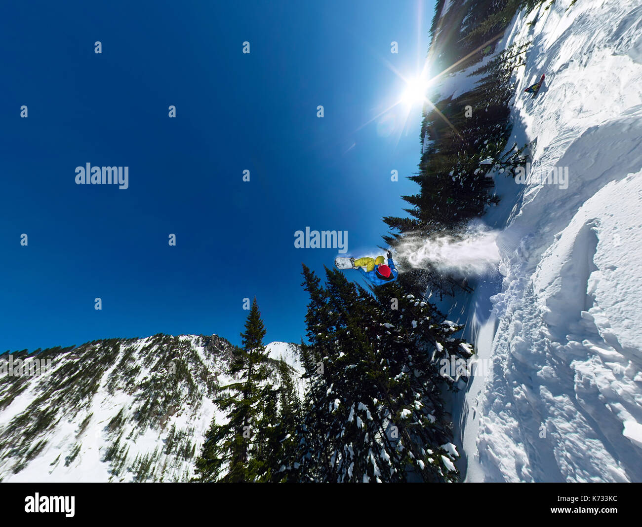 Snowboarder freerider jumping from snow ramp. Wide-angle aerial ...
