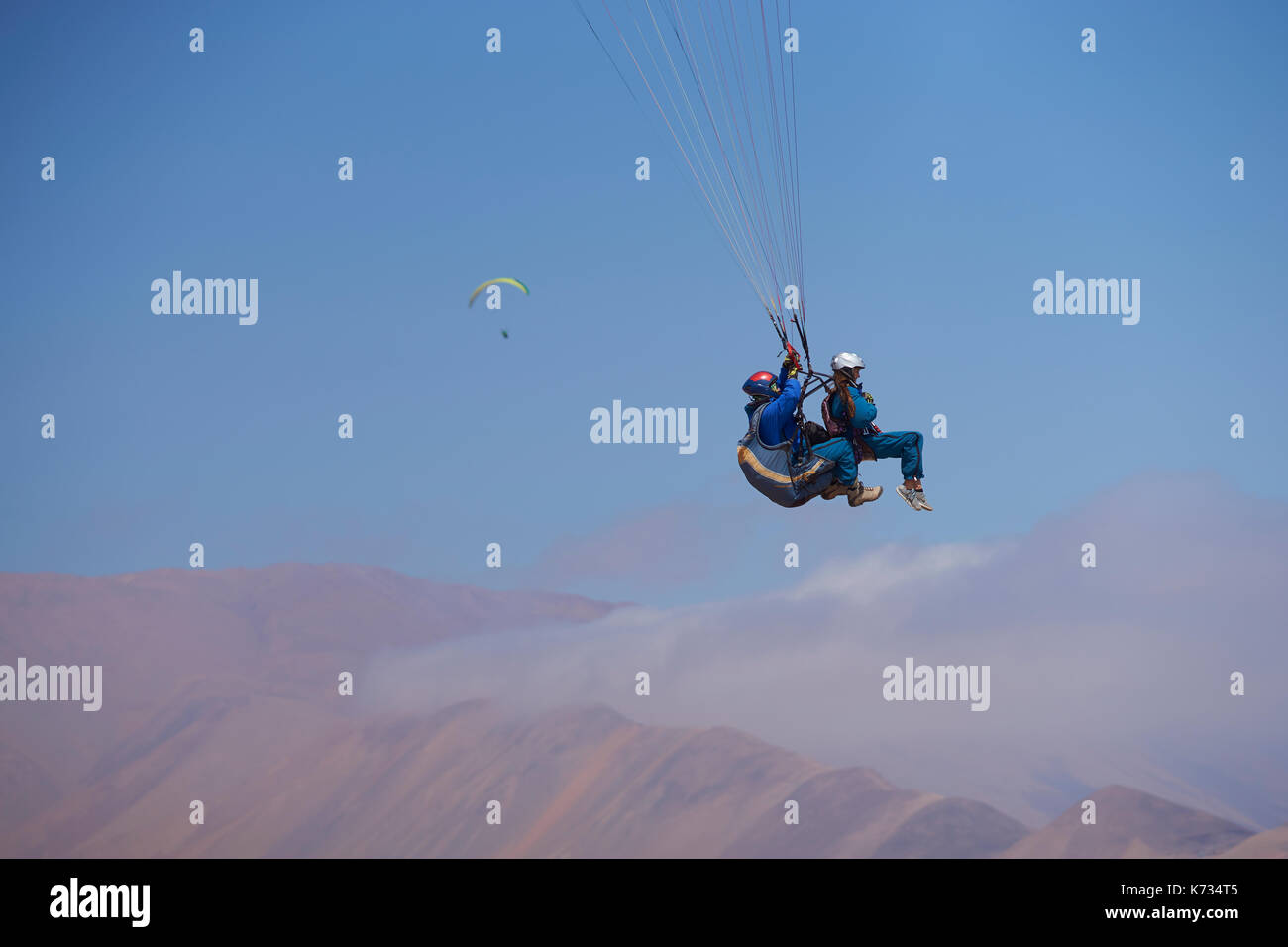 Tandem paragliding over the coastal city of Iquique on the northern ...