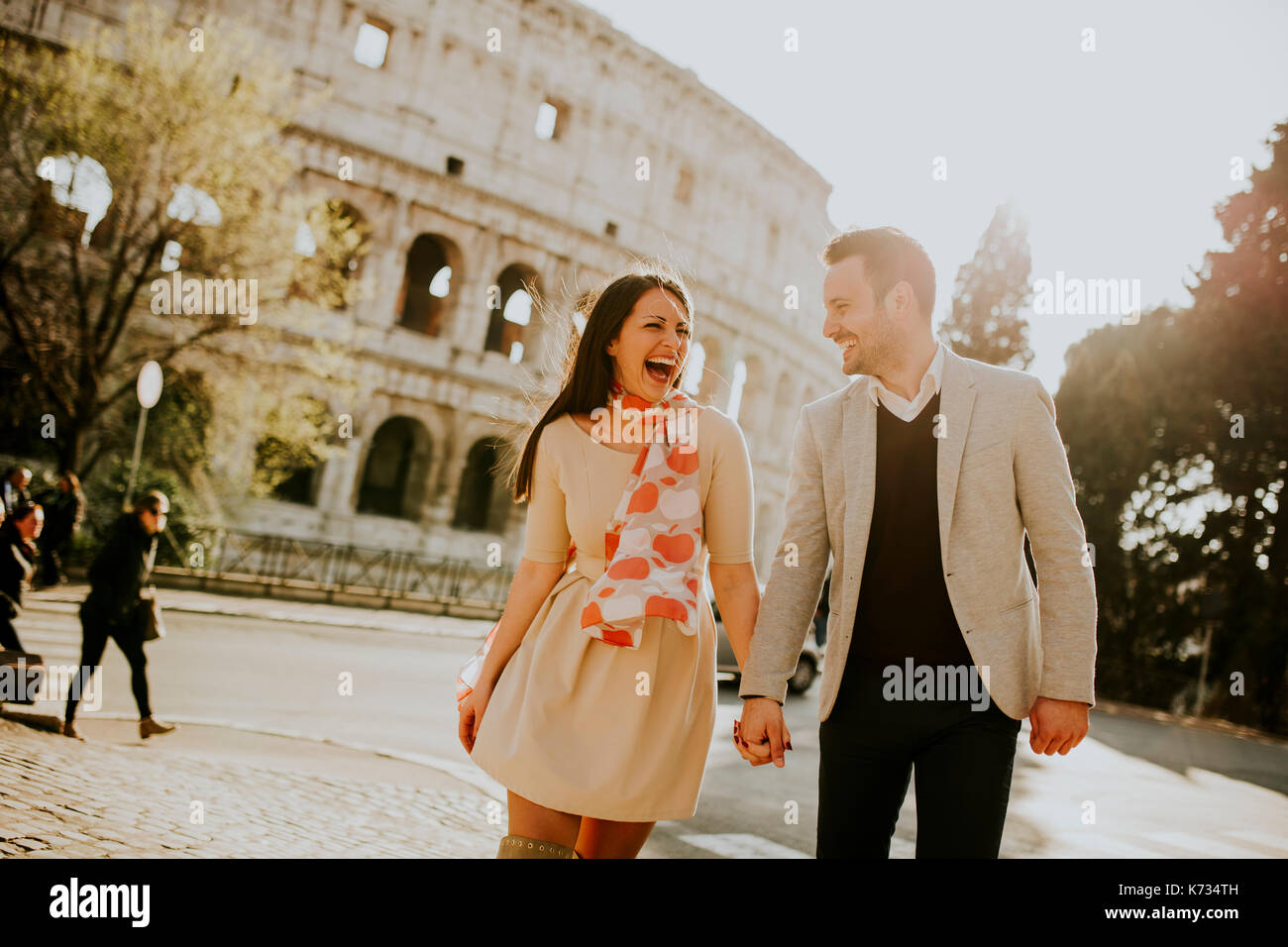 Loving couple visiting Italian famous landmarks Colosseum in Rome ...