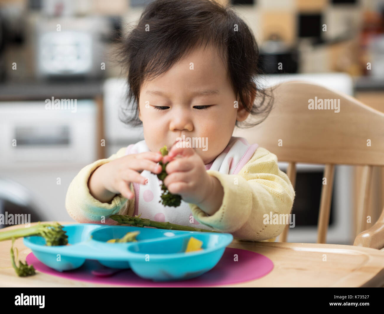 baby eating vegetable at home Stock Photo - Alamy