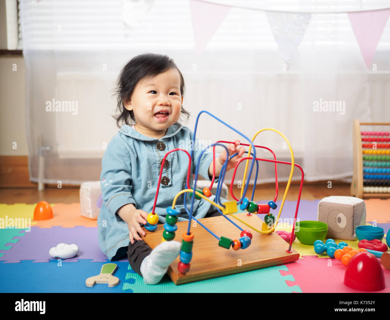 cute baby girl play toy at home Stock Photo - Alamy