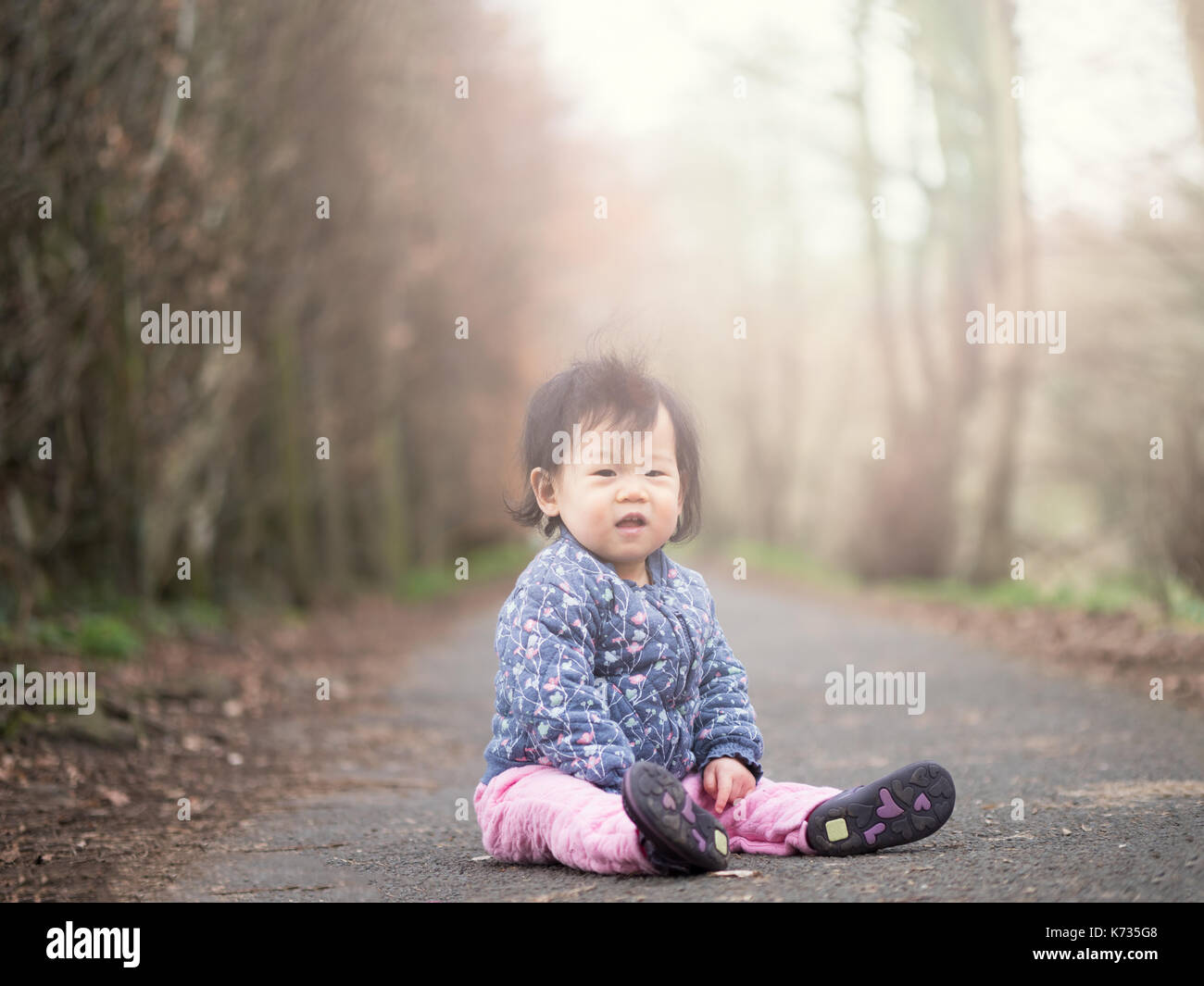 baby girl playing outdoor in spring time Stock Photo - Alamy